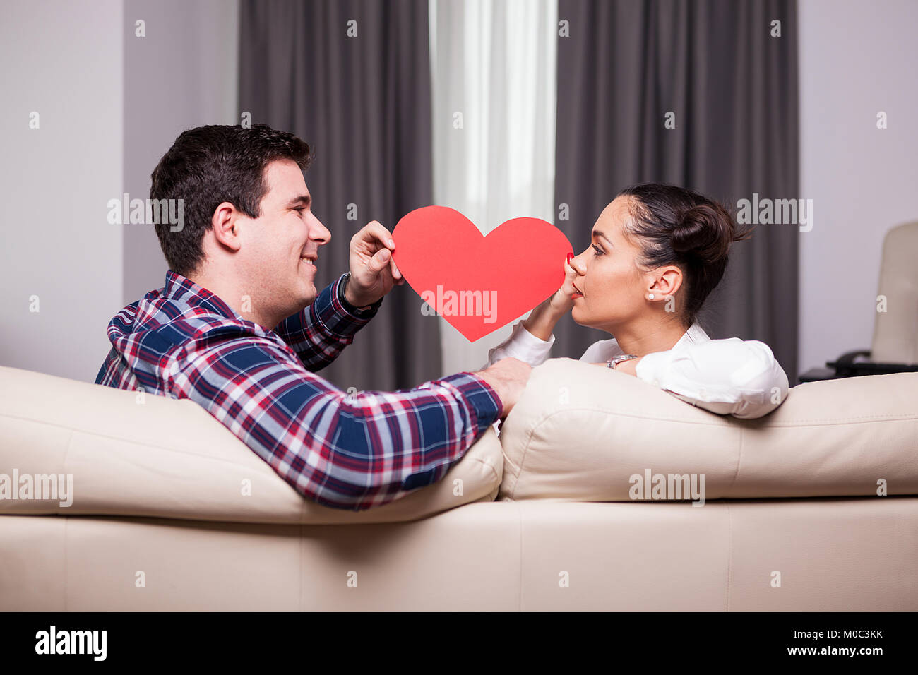 Inlove couple holding a red heart in their hands Stock Photo - Alamy