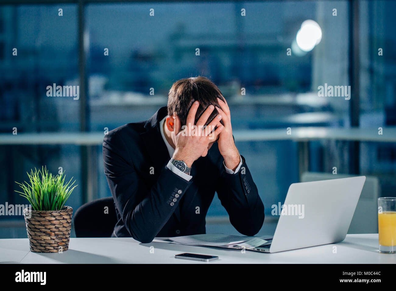 Stressed businessman having problems and headache at work Stock Photo ...