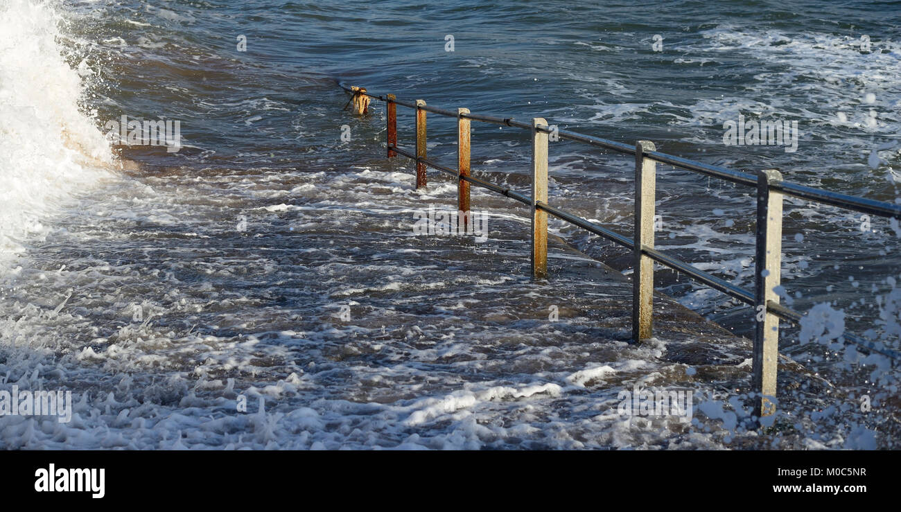 Seafront railings disappearing into the water at high tide Stock Photo ...