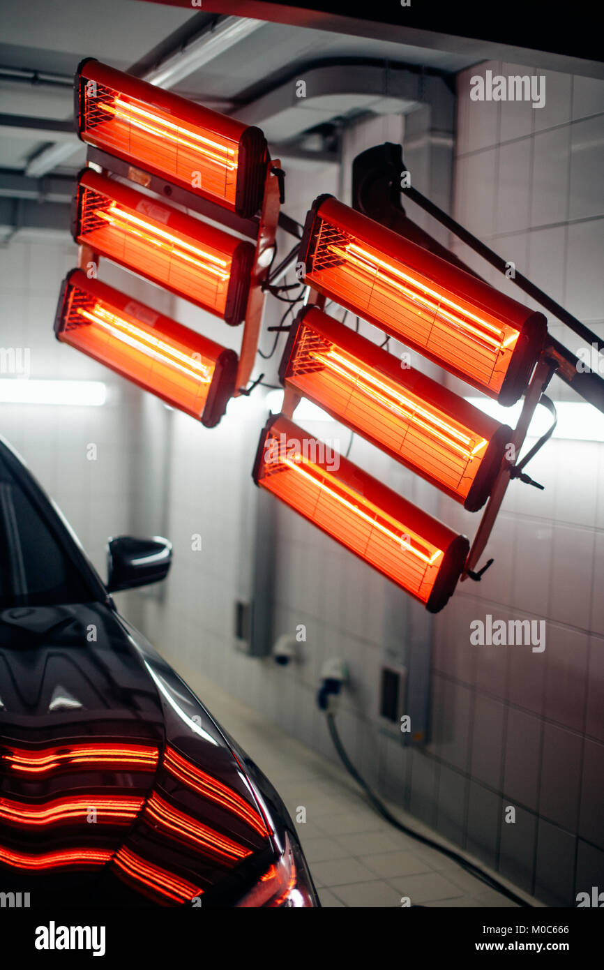 lamps for drying the ceramic coating are behind car Stock Photo - Alamy