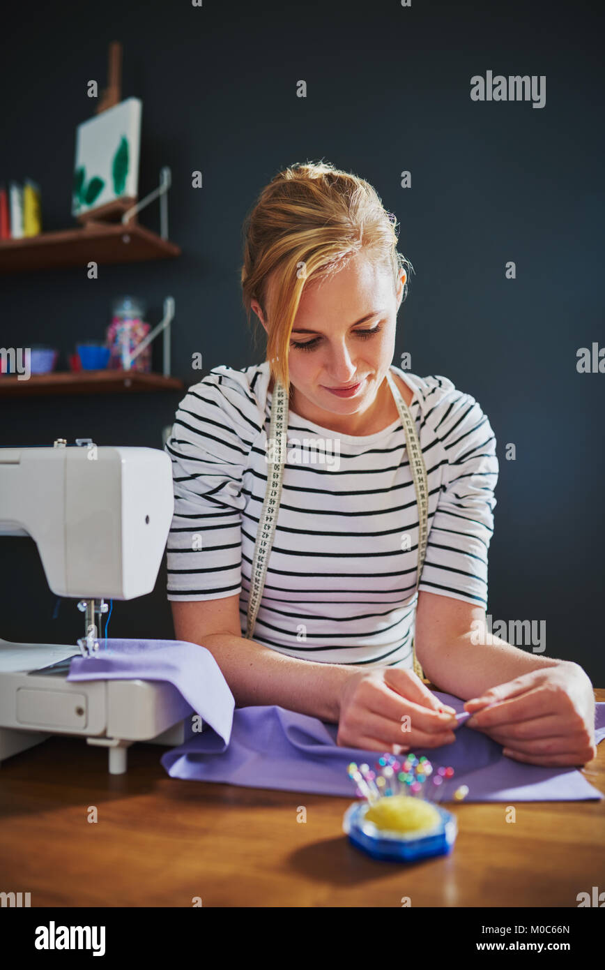 Female designer creating clothes on a sewing machine Stock Photo - Alamy