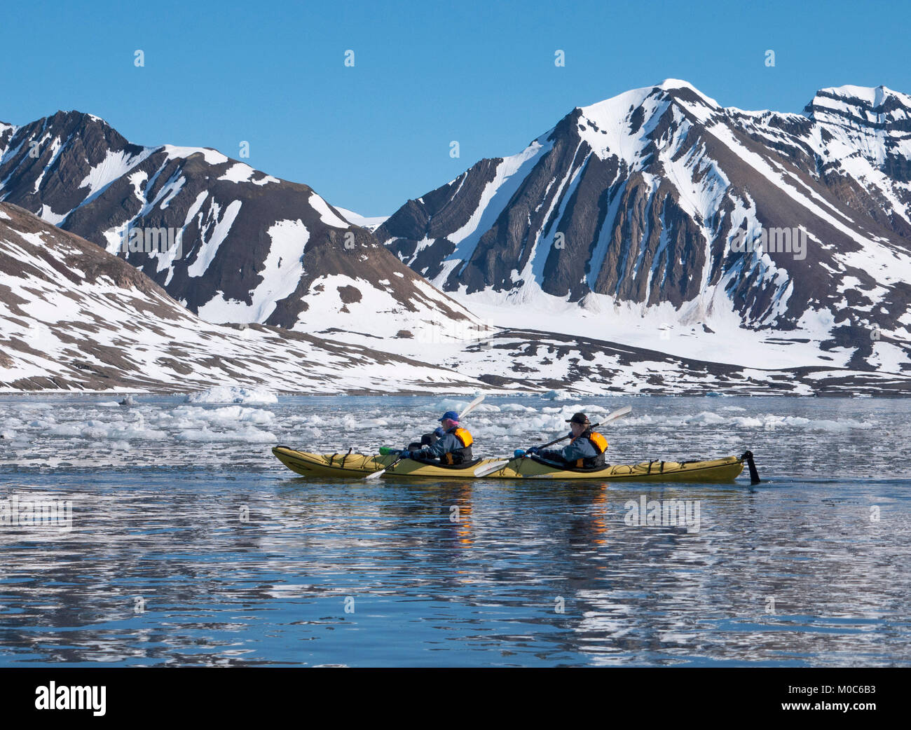 Kayaking in the arctic waters of Lillhook Fjord on the archipelago of ...