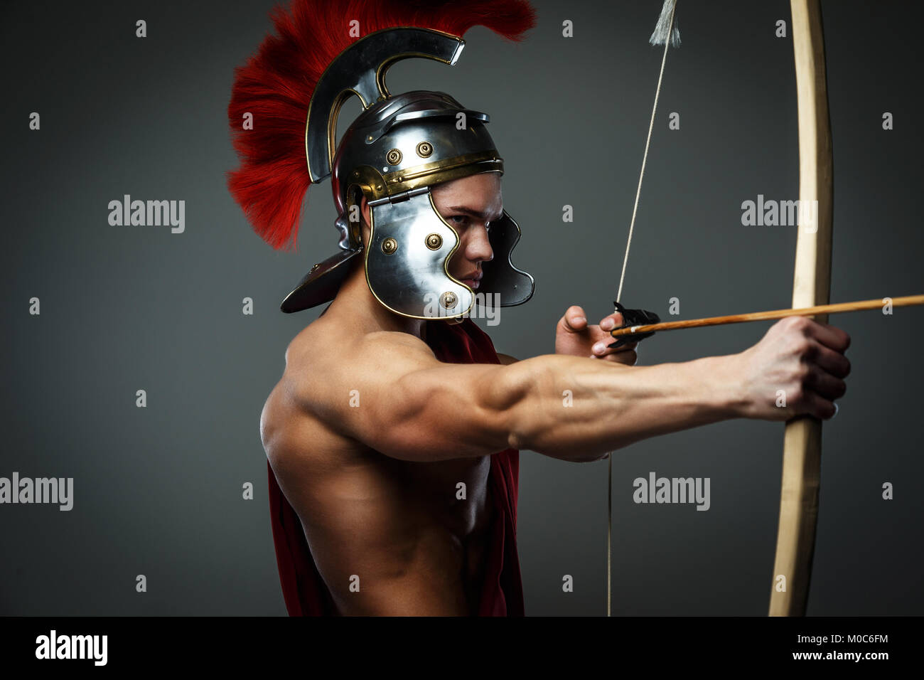 Muscular male in roman armor Stock Photo - Alamy