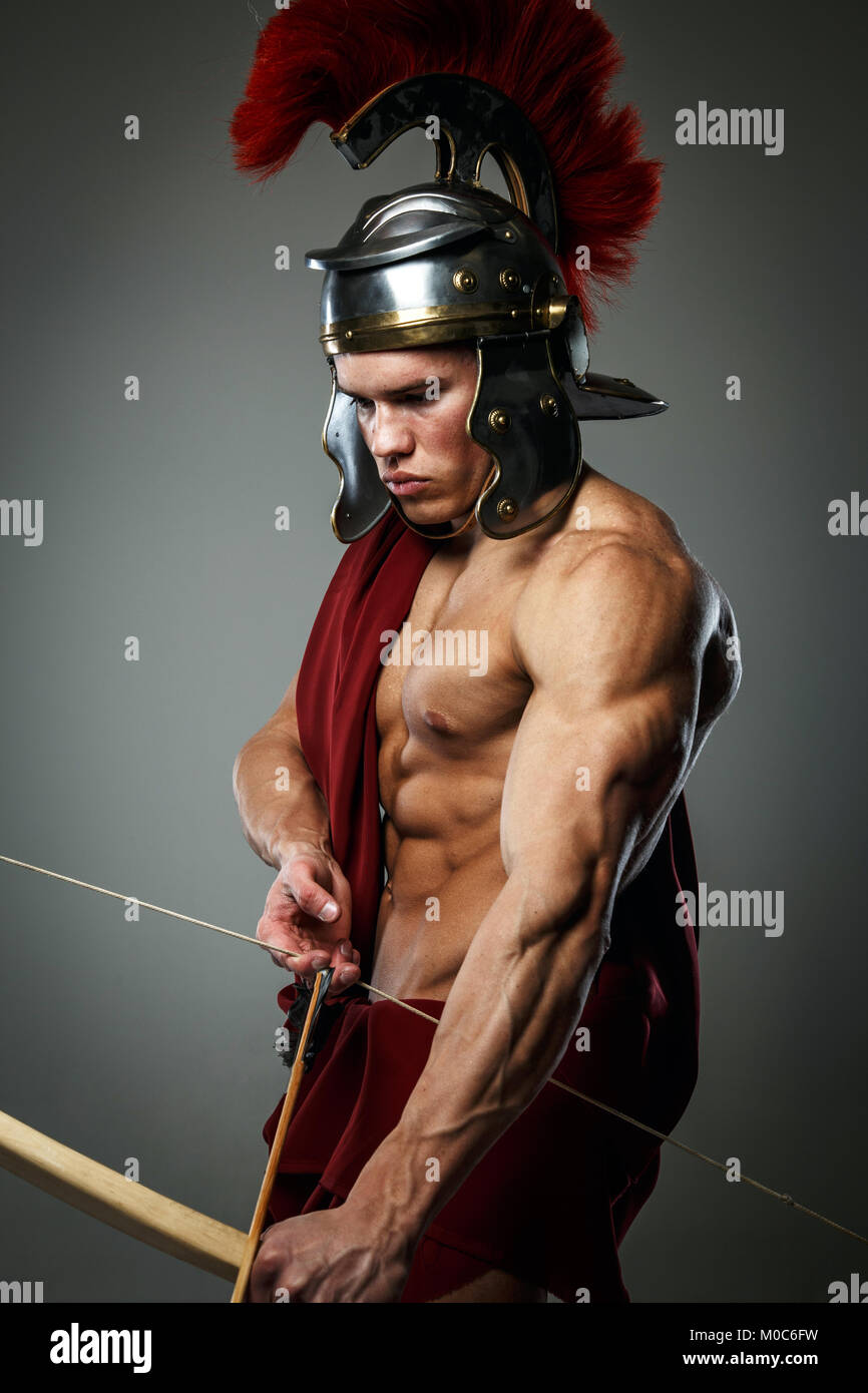 Muscular male in roman armor Stock Photo - Alamy