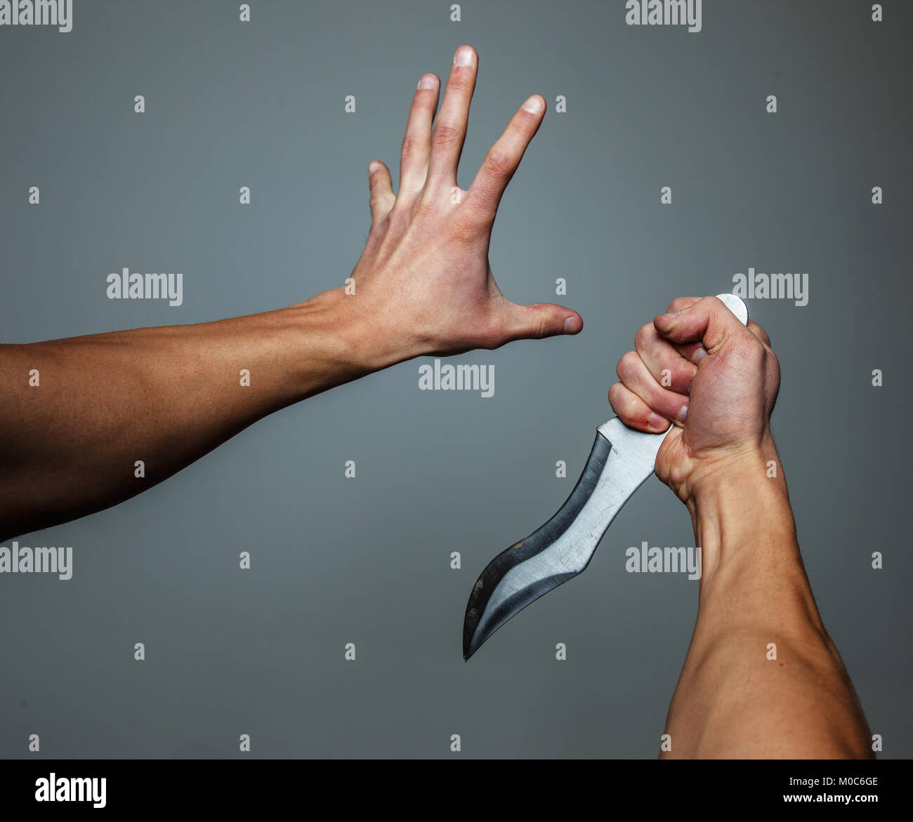 Arms with knife Stock Photo - Alamy
