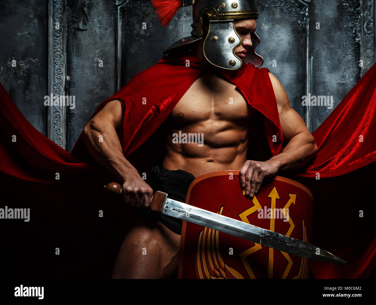 Warrior with trained body holds swor and shield Stock Photo - Alamy