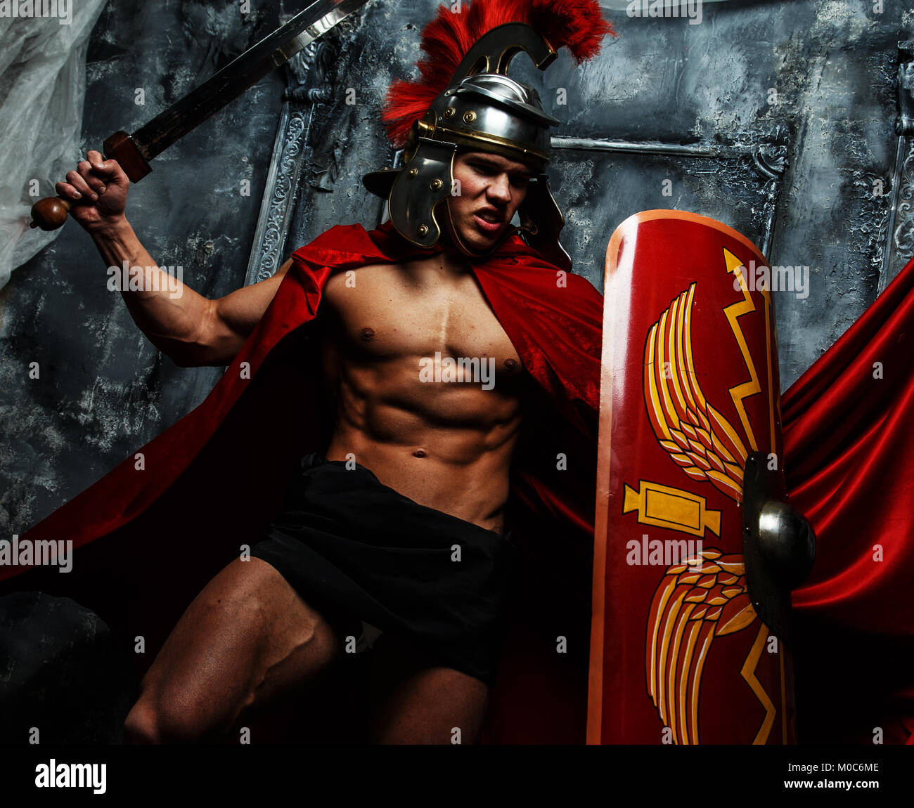 Warrior with trained body holds swor and shield Stock Photo - Alamy