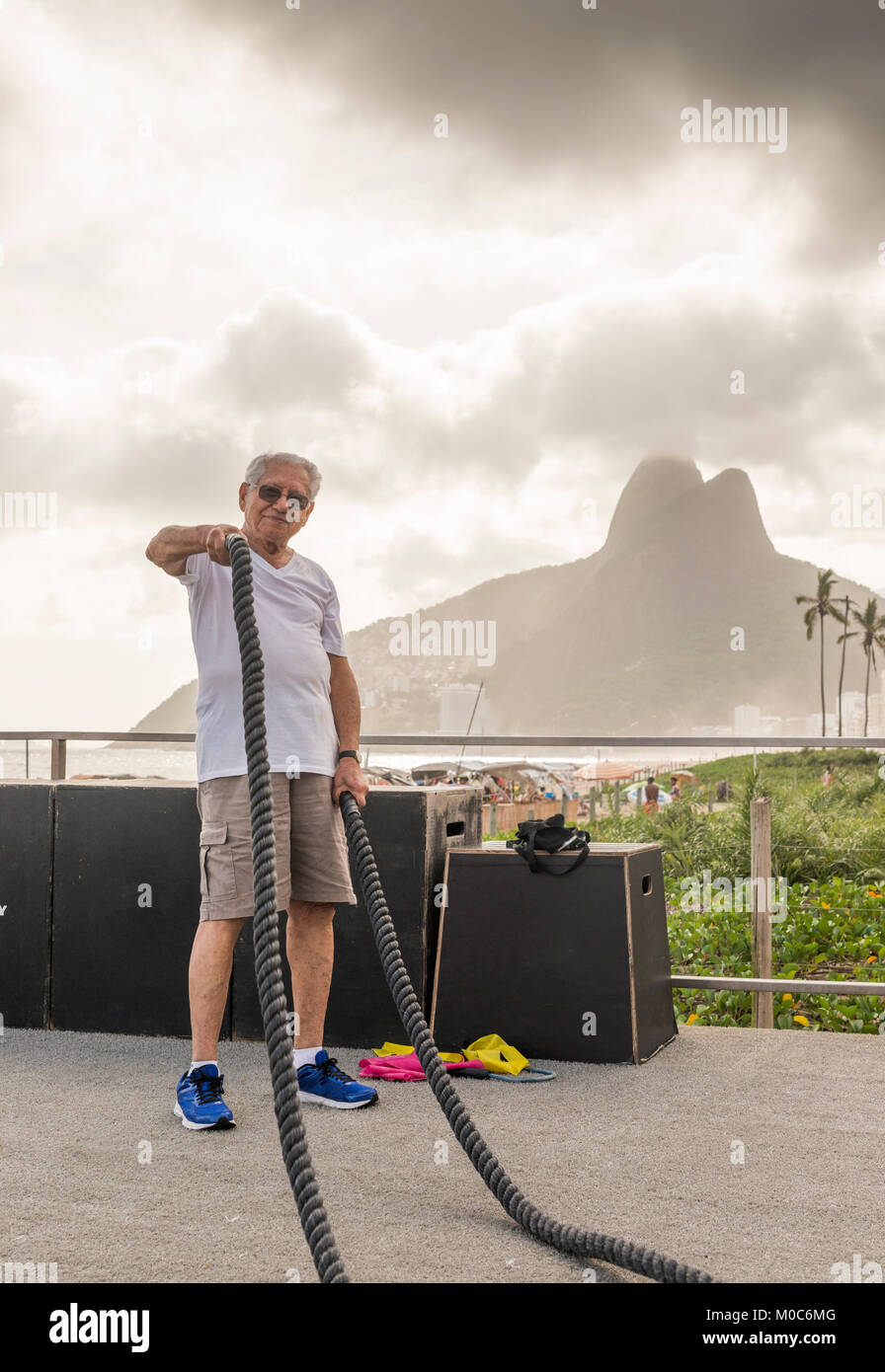 Model Released: Older man (80-89) exercising with battling rope at ...
