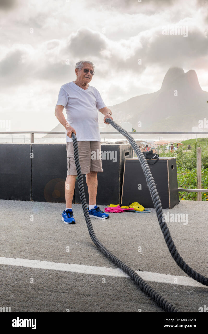 Model Released: Older man (80-89) exercising with battling rope at ...