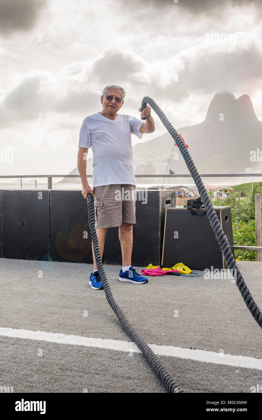 Model Released: Older man (80-89) exercising with battling rope at ...