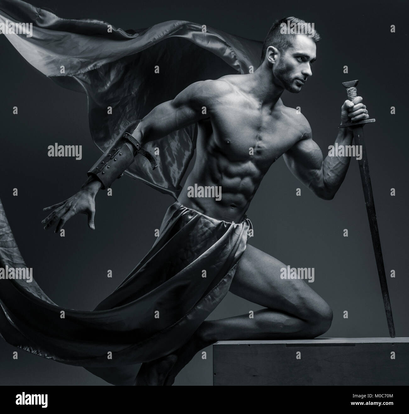 Shirtless guy holding sword Stock Photo - Alamy