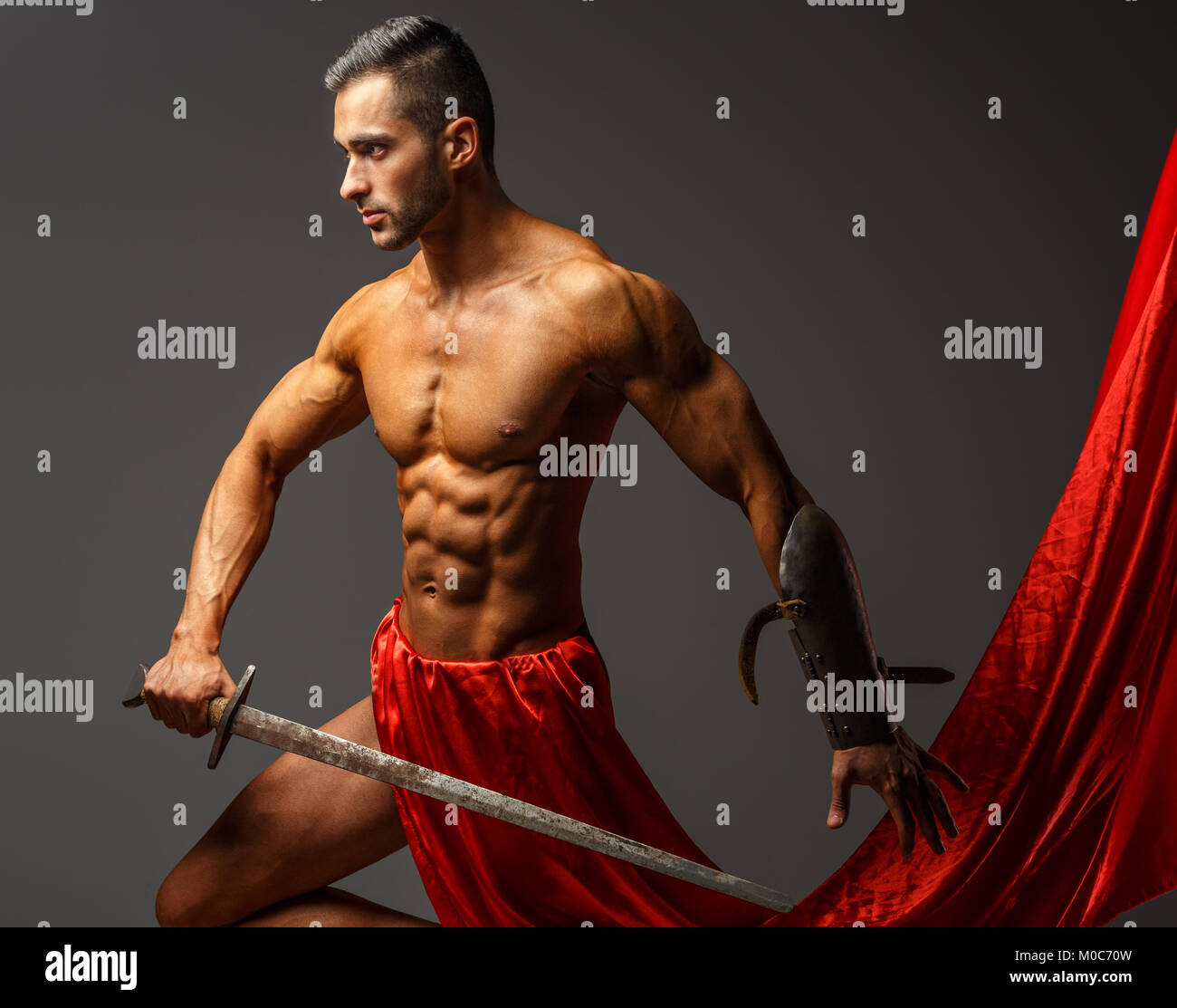 Shirtless guy holding sword Stock Photo - Alamy