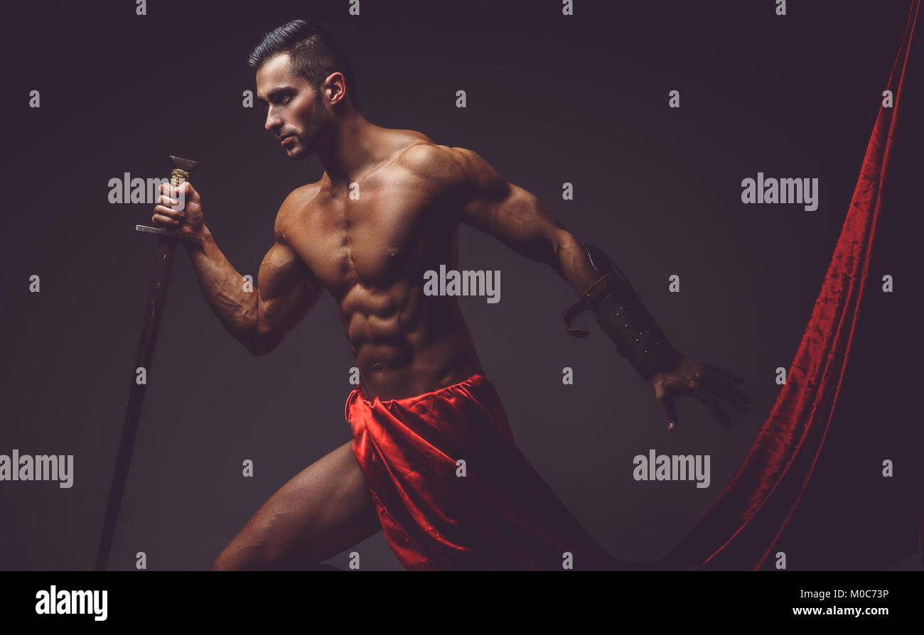 A man holding a sword Stock Photo - Alamy