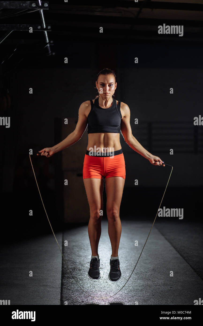 woman Exercises with Jump or Skipping Rope in Gym Stock Photo - Alamy