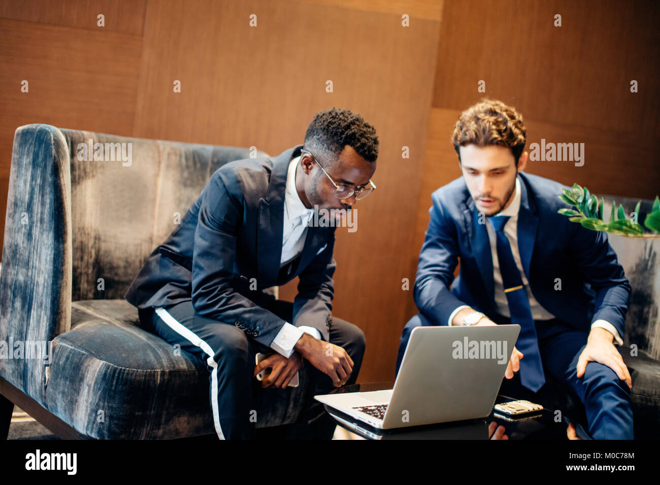 businessman using laptop to discuss information with colleague in ...