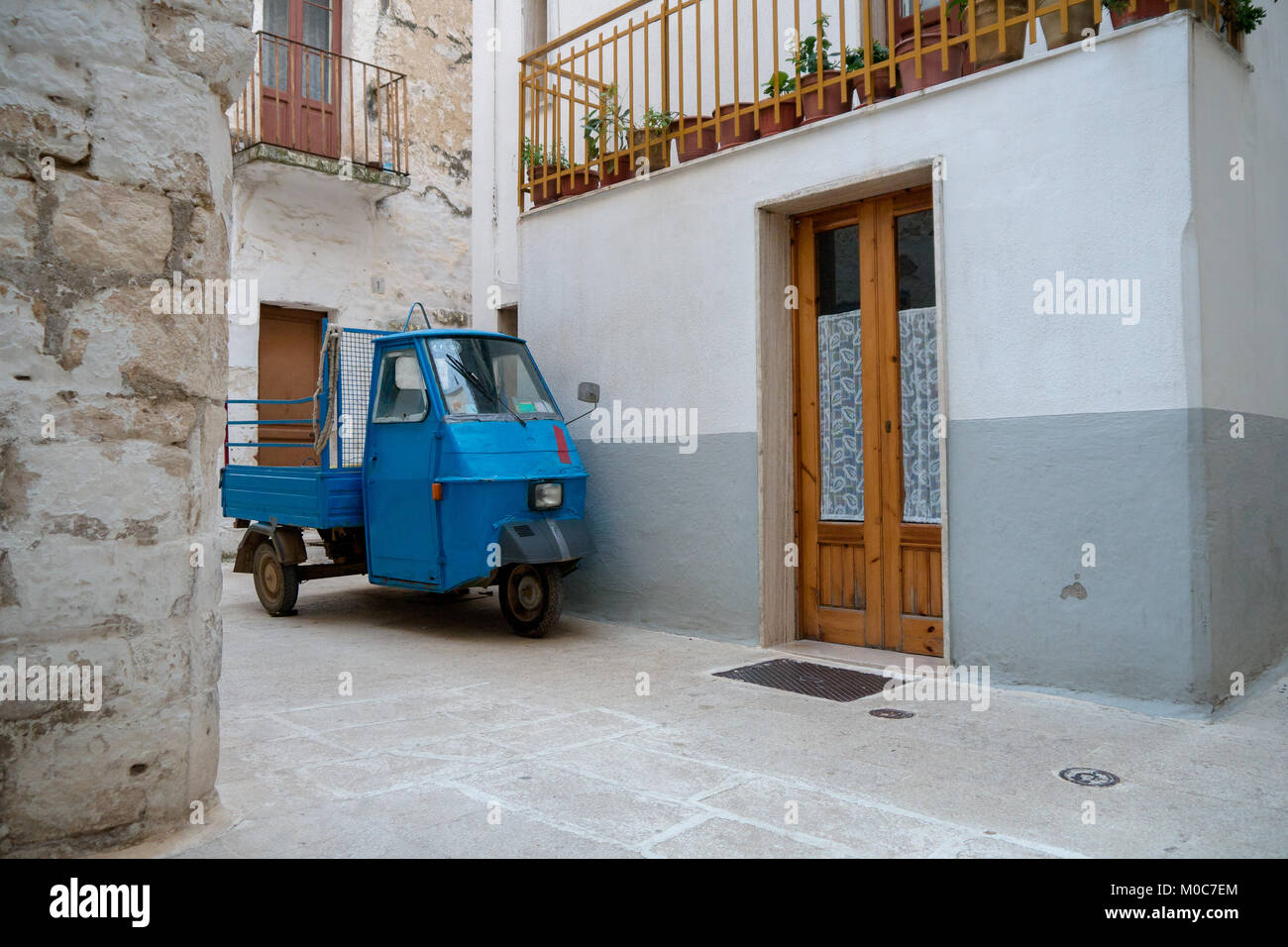 Three-wheeler van in a old town. Apulia, Italy Stock Photo - Alamy