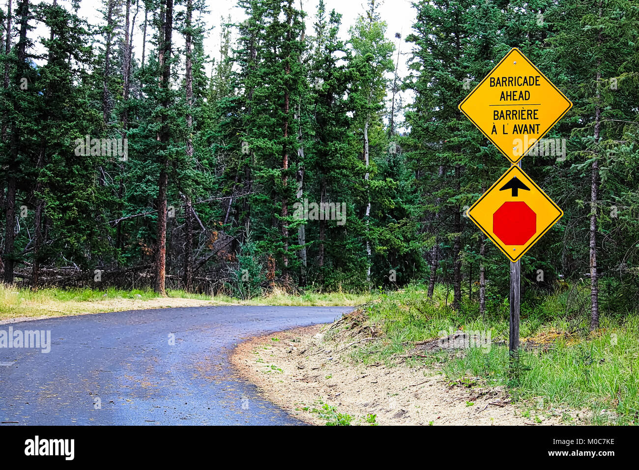 A Stop and Barricade Ahead sign along a road Stock Photo - Alamy