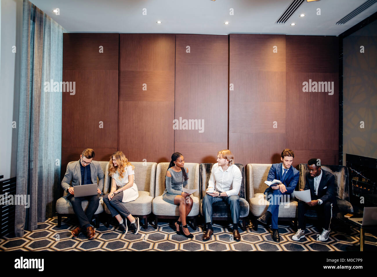 Business people waiting for job interview, talking Stock Photo - Alamy