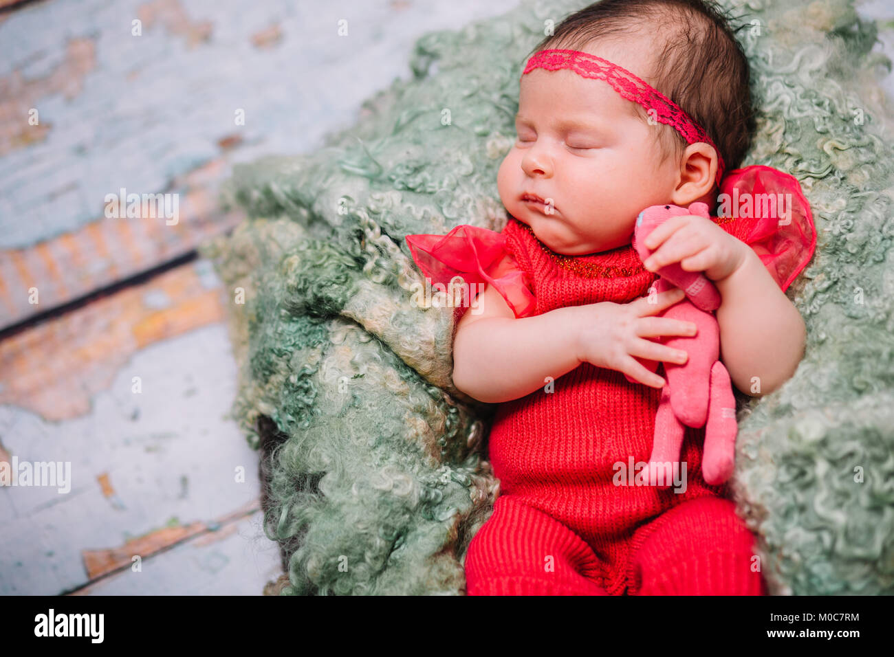 close-up portrait sleeping baby in red Stock Photo - Alamy