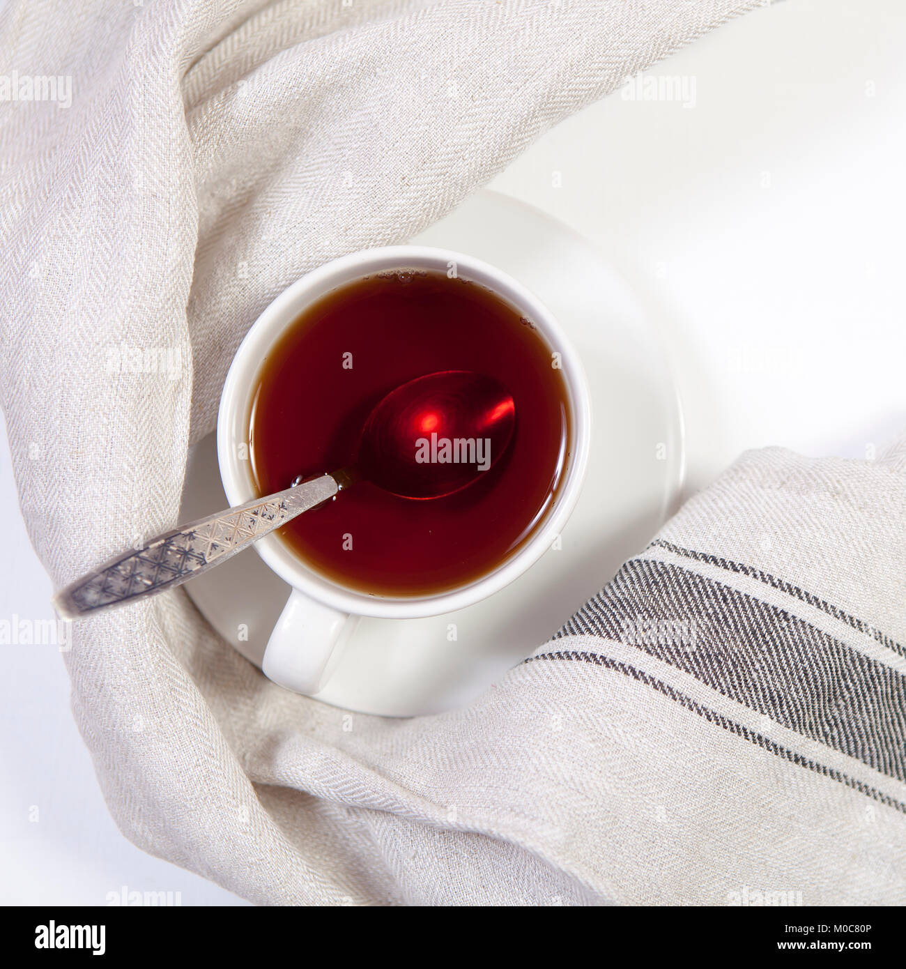 Cup of tea with spoon on white background Stock Photo - Alamy