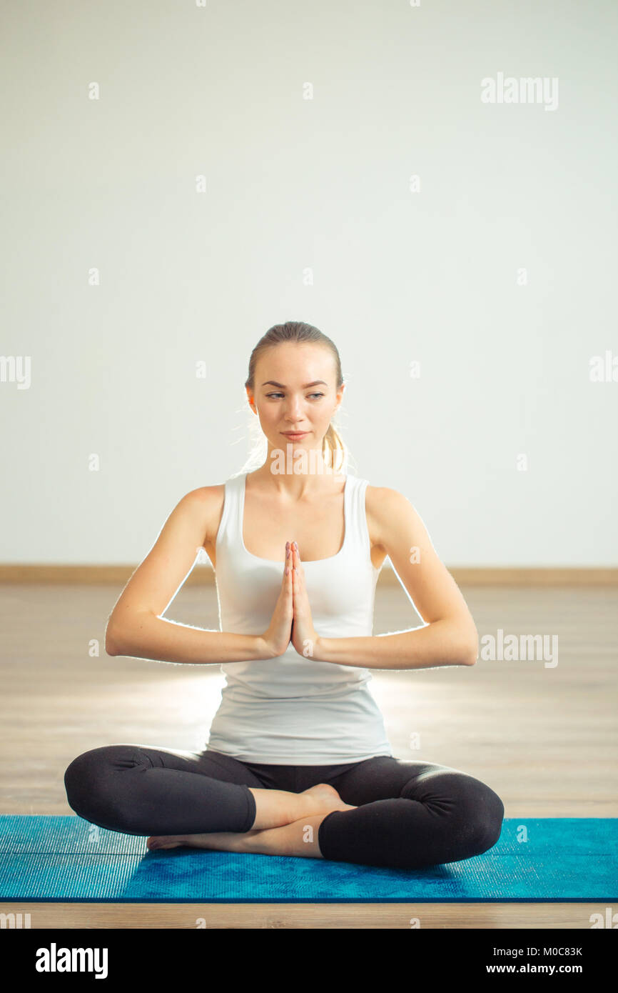 woman practicing yoga, sitting in Padmasana, exercise, Lotus pose ...
