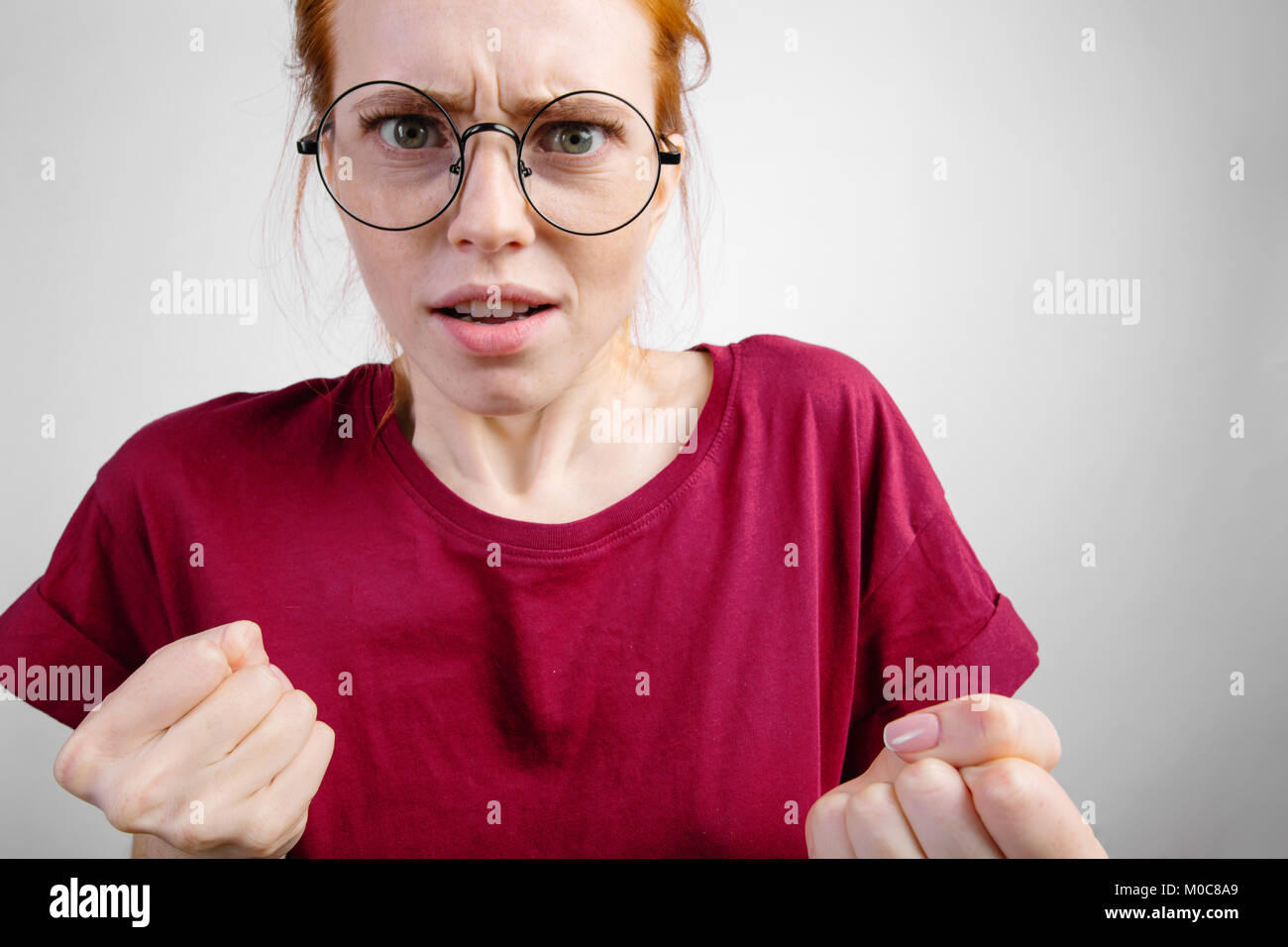 angry woman standing with raised knuckles on white background Stock ...