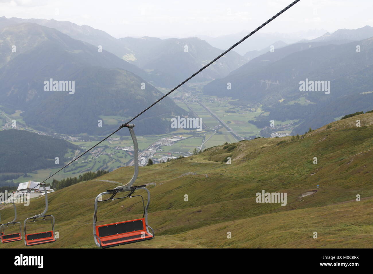 Chairlift ski lift in european Alps. Transporting hikers in summer ...