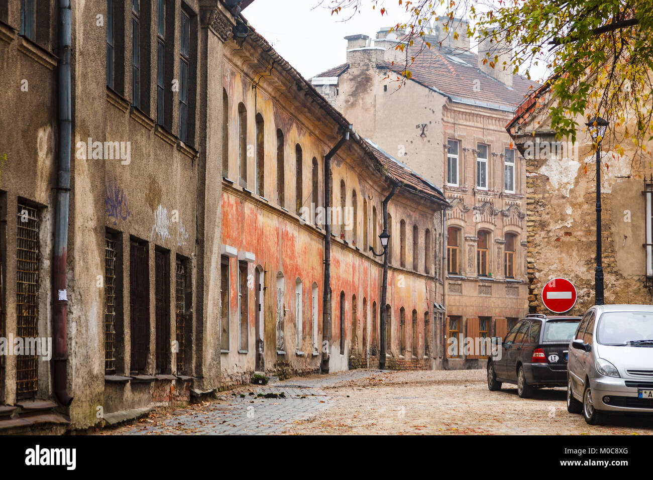 Dilapidated, run-down side street of empty old terraced houses with ...