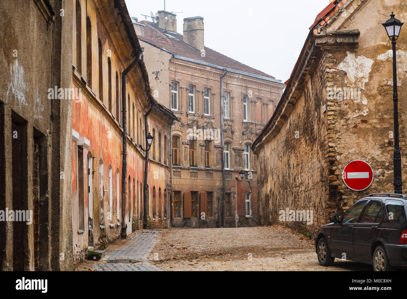 Dilapidated, run-down side street of empty old terraced houses with ...