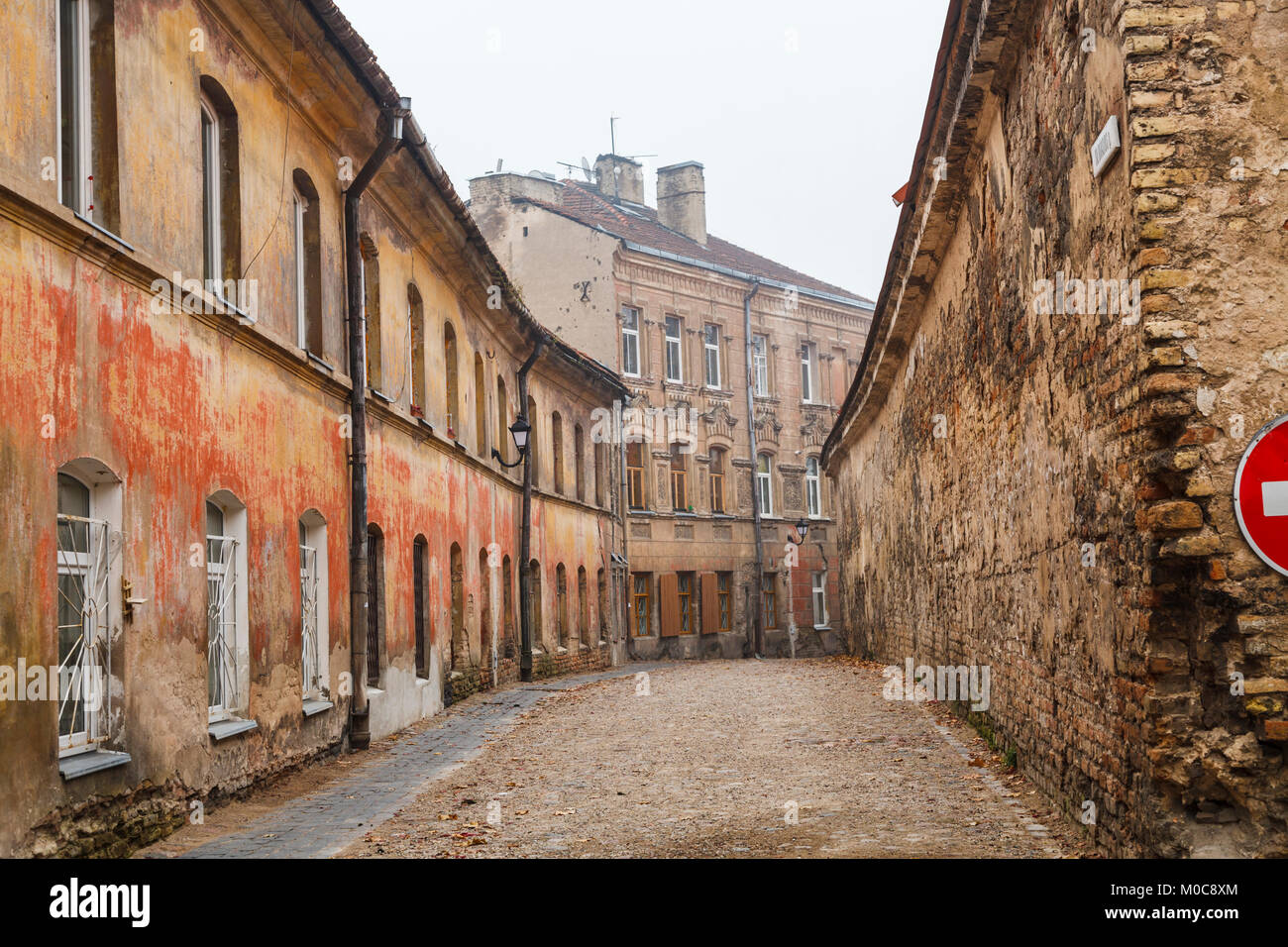 Dilapidated, run-down side street of empty old terraced houses with ...