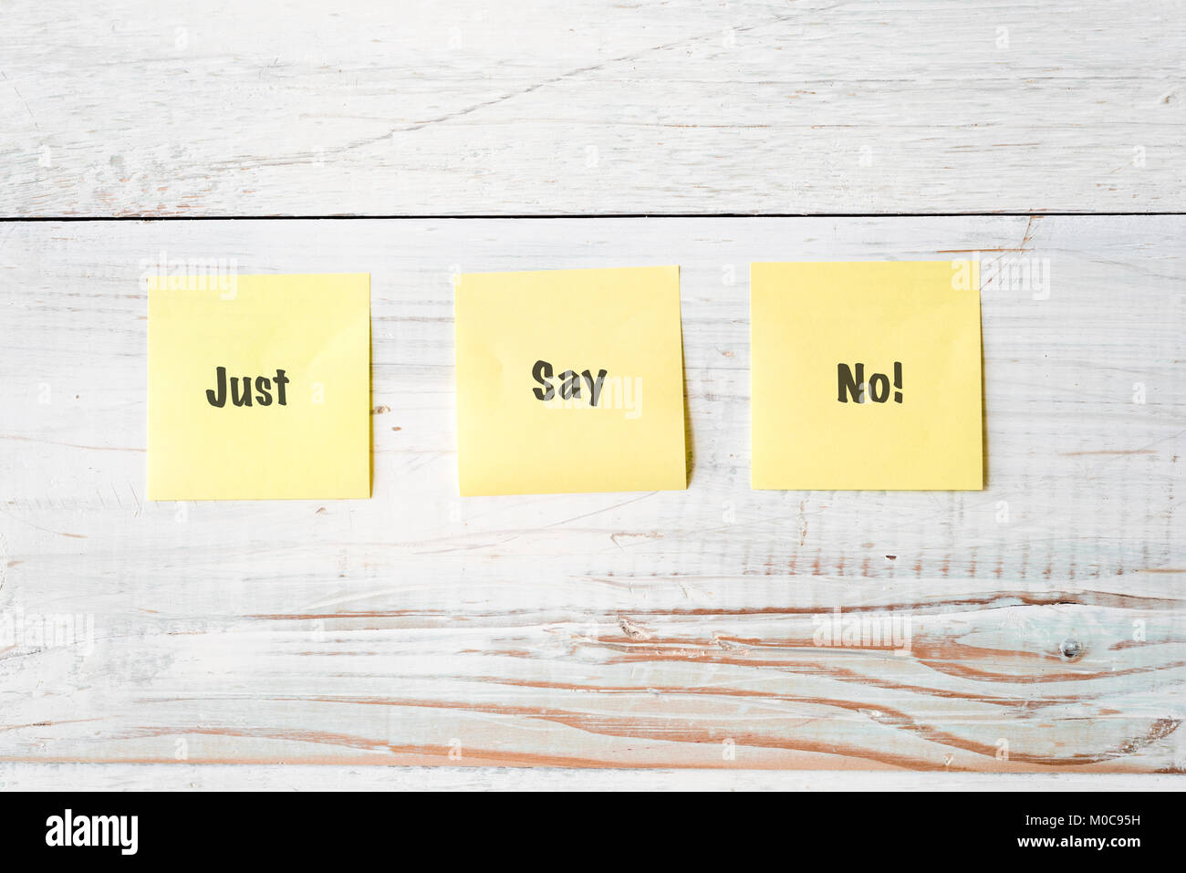 three yellow Post It notes with message Just Say No! against weathered ...