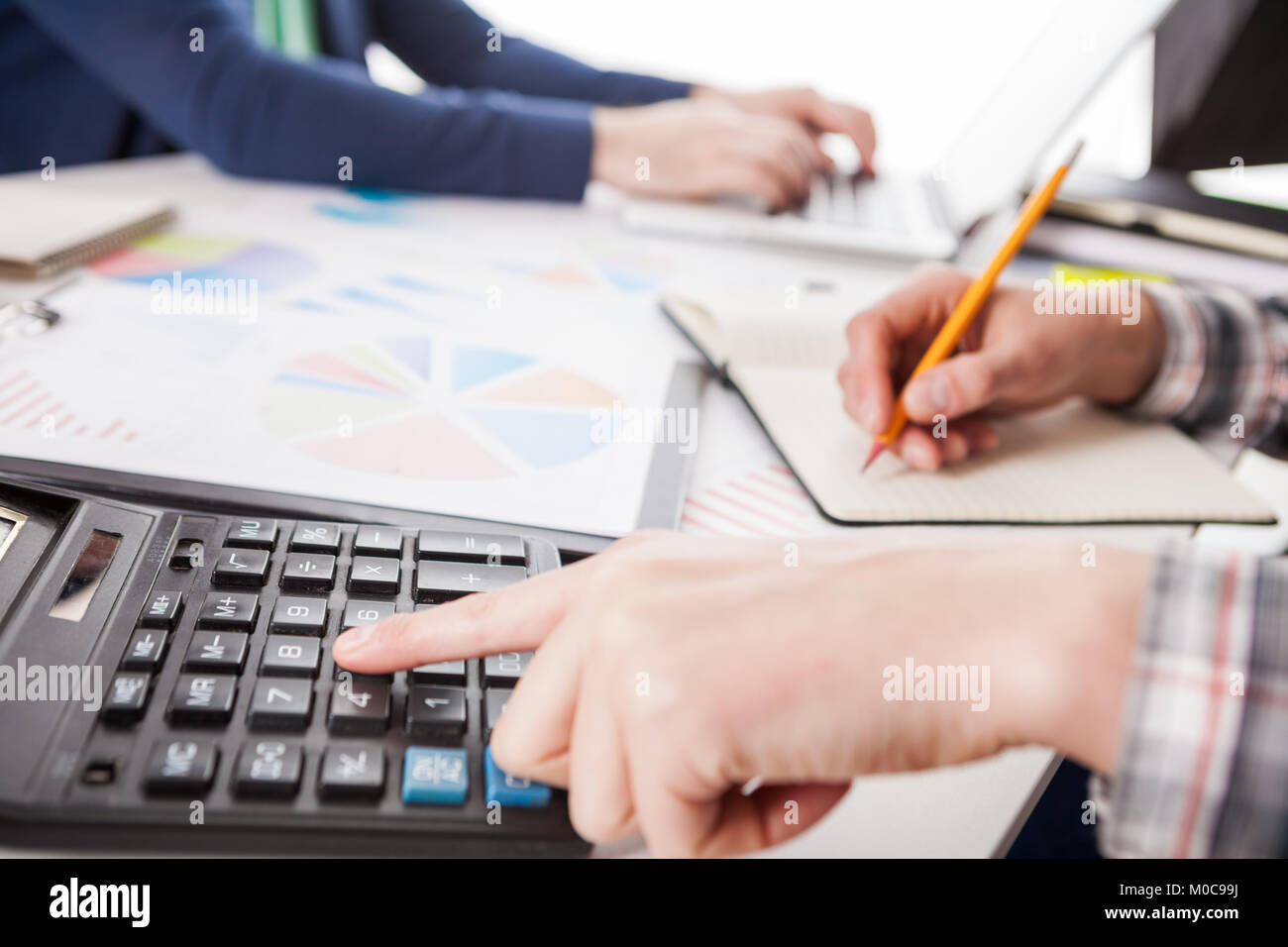 Business people discussing the charts and graphs showing the results of ...