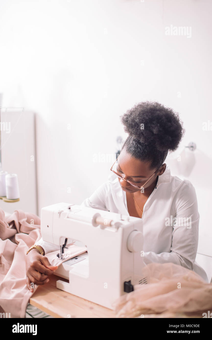 african seamstress sews clothes Stock Photo - Alamy