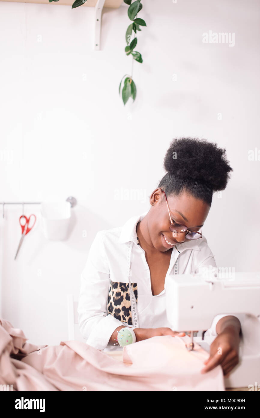 african seamstress sews clothes Stock Photo - Alamy