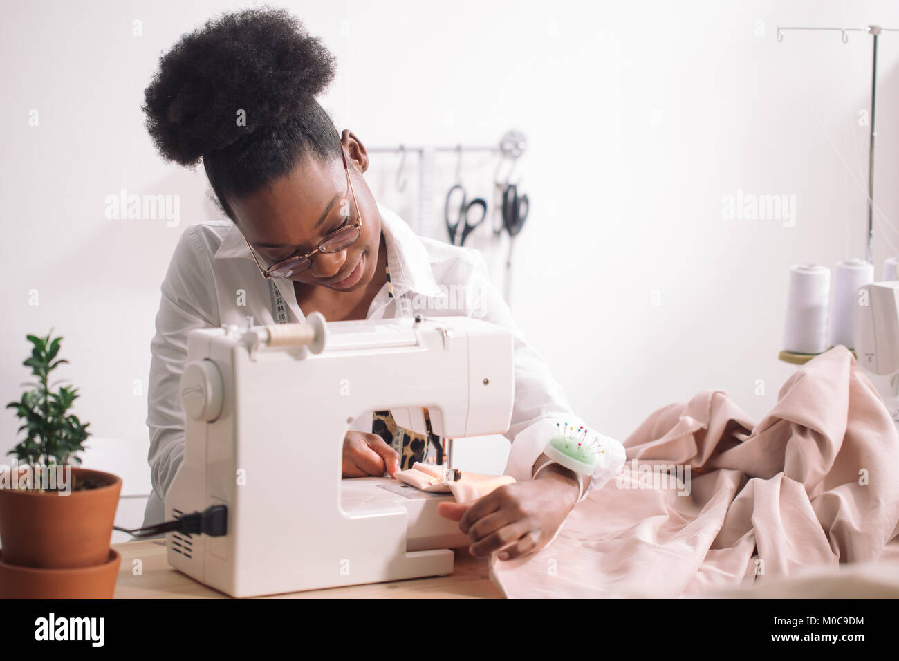 african seamstress sews clothes Stock Photo - Alamy