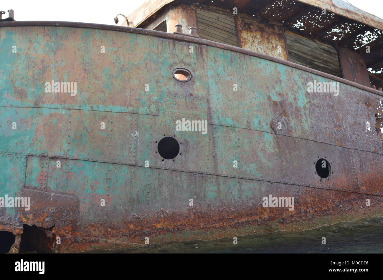 Close-up of a destroyed old rusty ship trunk half sunken in a sea Stock ...