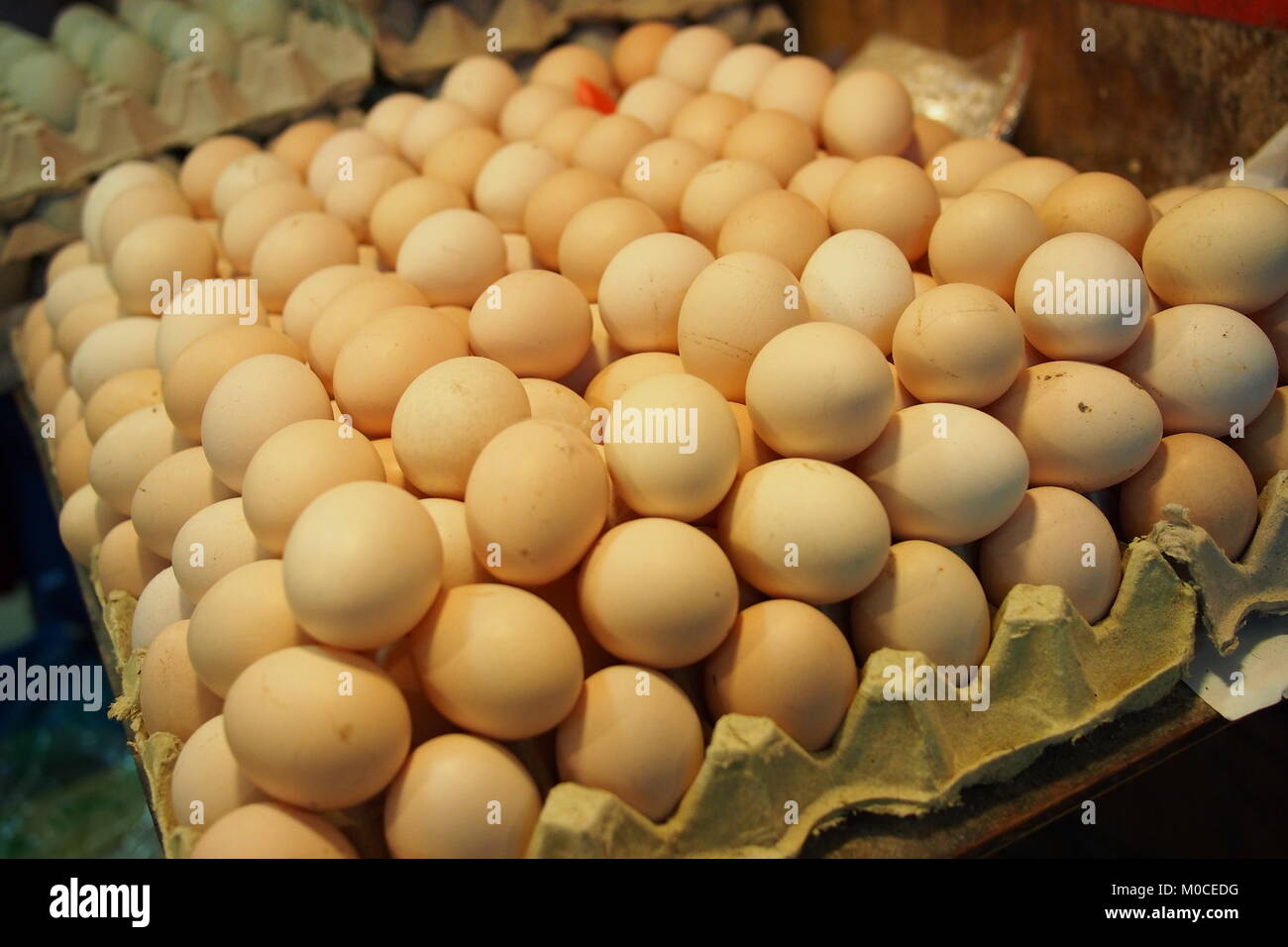 Eggs stacked on paper tray selling in Asia market Stock Photo - Alamy