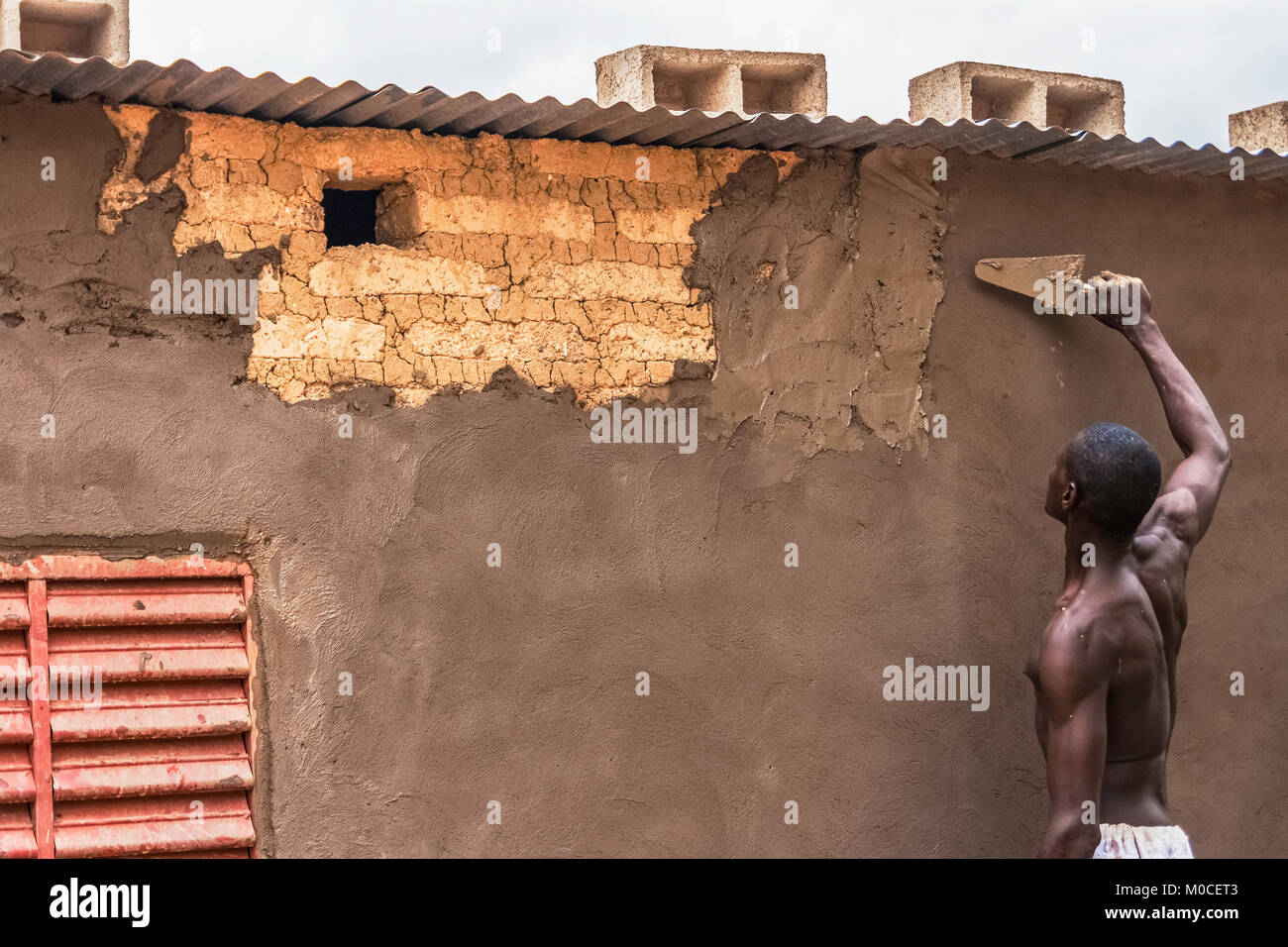 An african bricklayer working on a wall, Ouagadougou, Burkina Faso ...