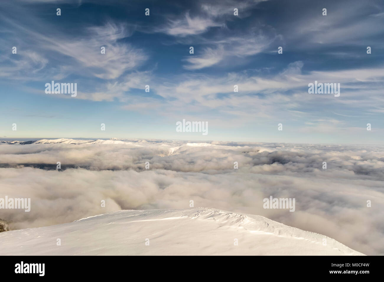 peaks of mountains above the clouds. Winter landscape Stock Photo - Alamy