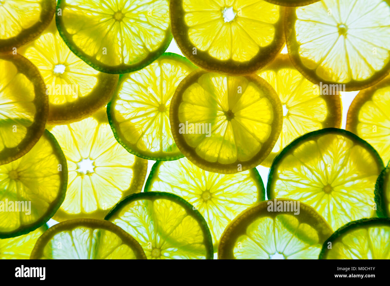 Background of backlit fresh lemon and lime slices Stock Photo - Alamy
