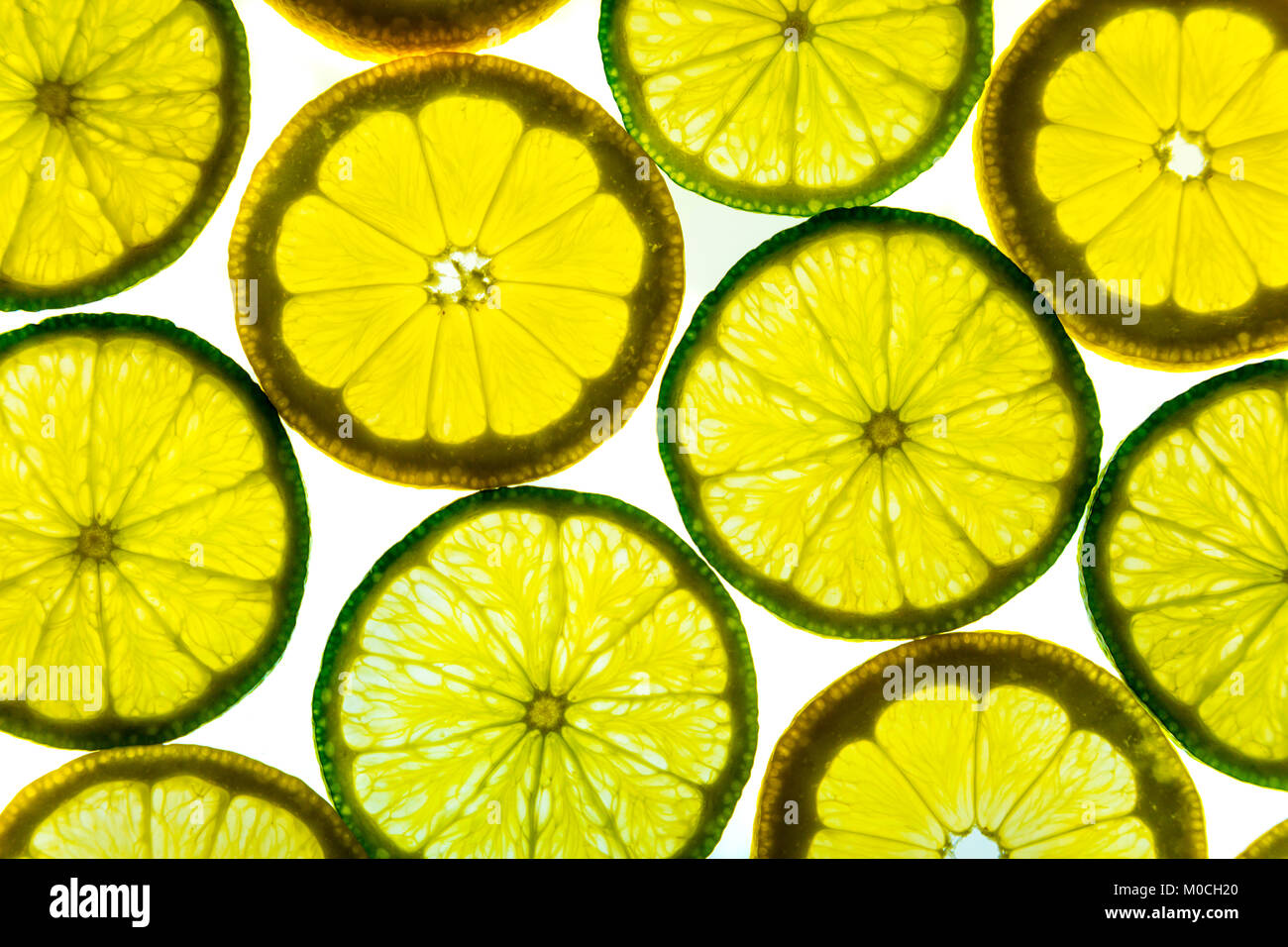 Background of backlit fresh lemon and lime slices Stock Photo - Alamy