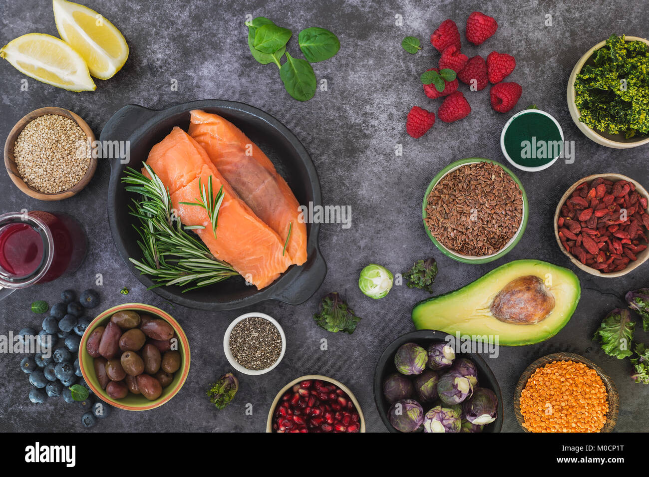 Fish with fresh healthy food ingredients featuring seeds, legumes ...