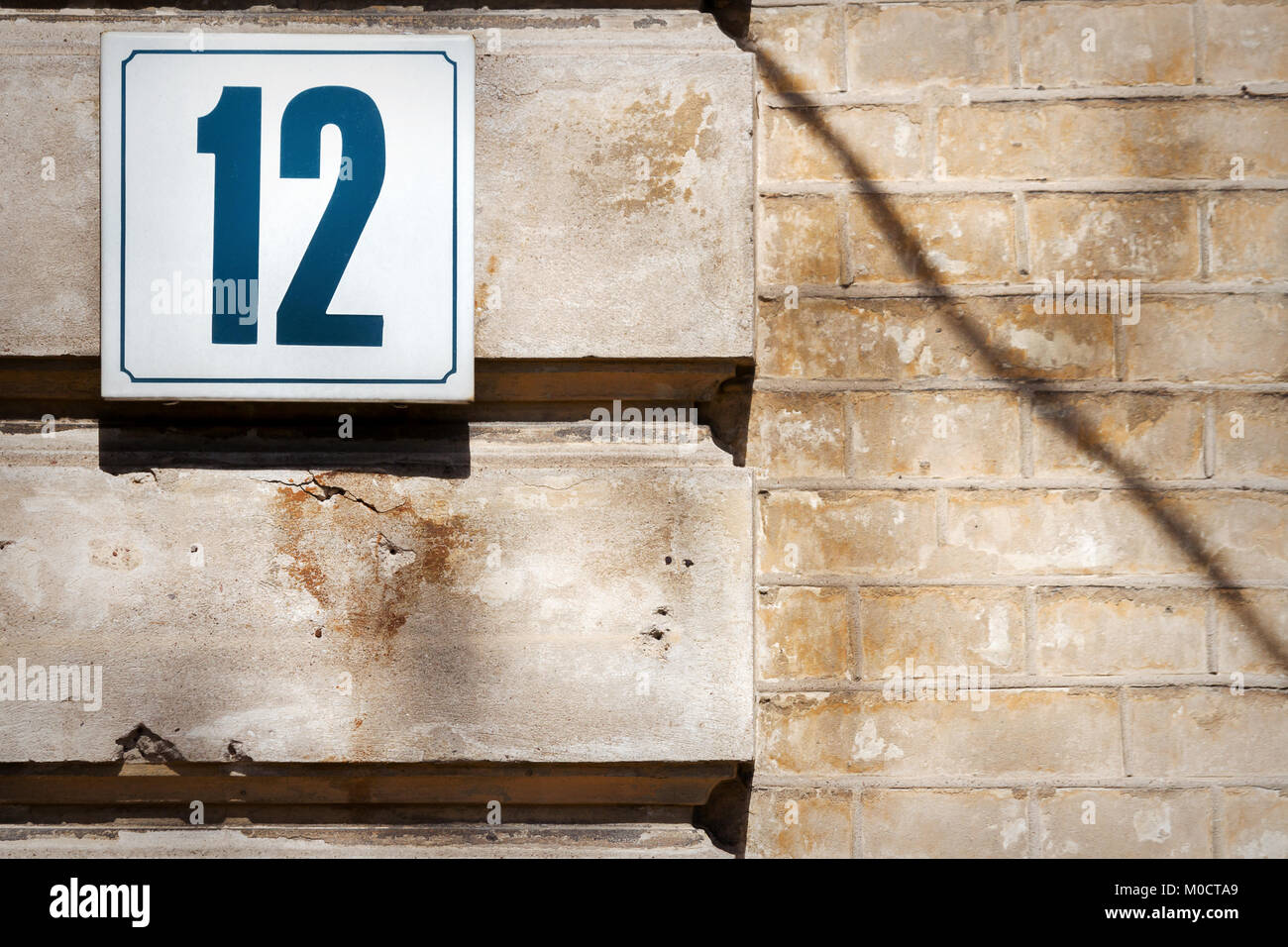 Number 12 on textured concrete wall Stock Photo - Alamy