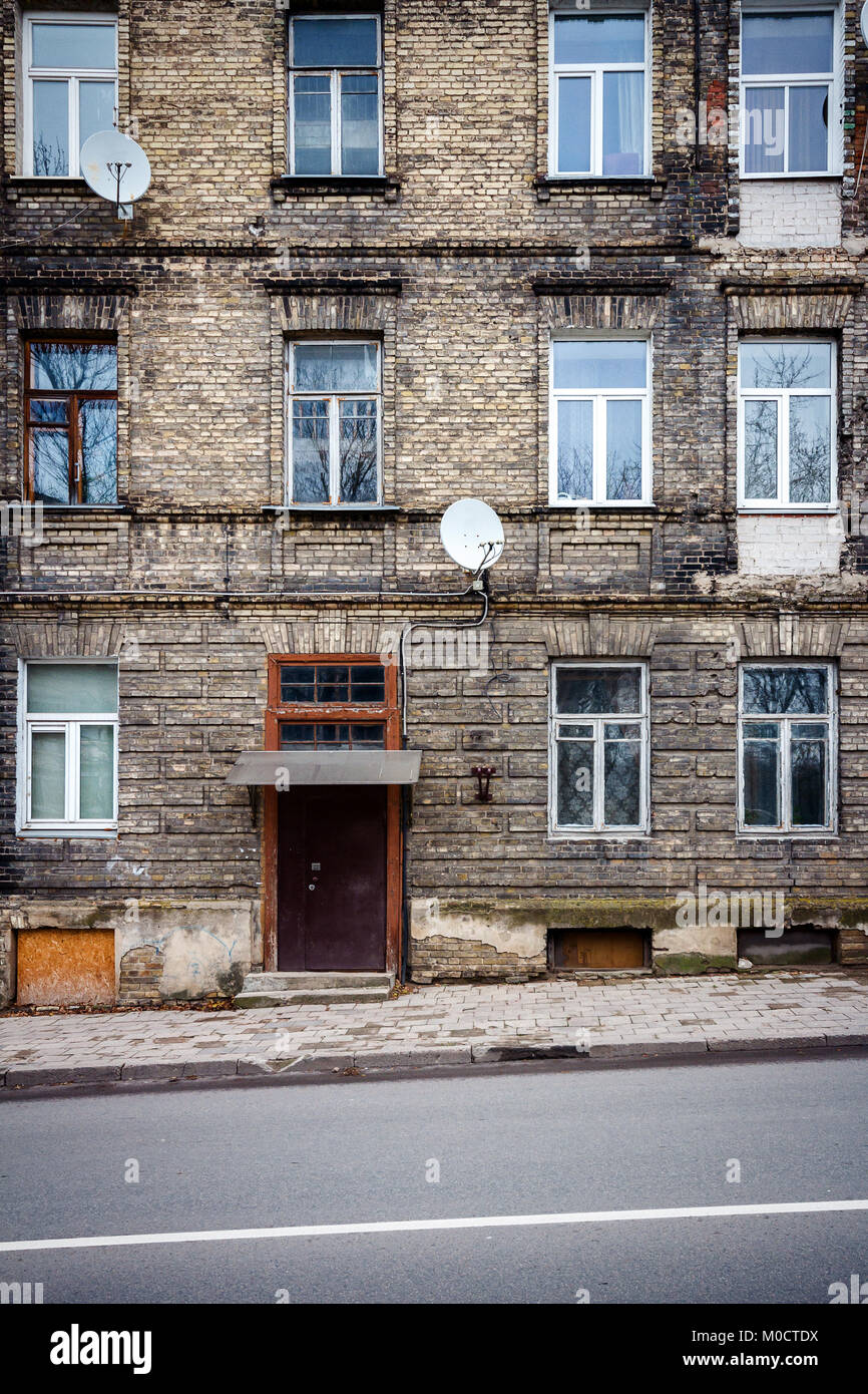 Old weathered street wall with some windows and doors Stock Photo - Alamy