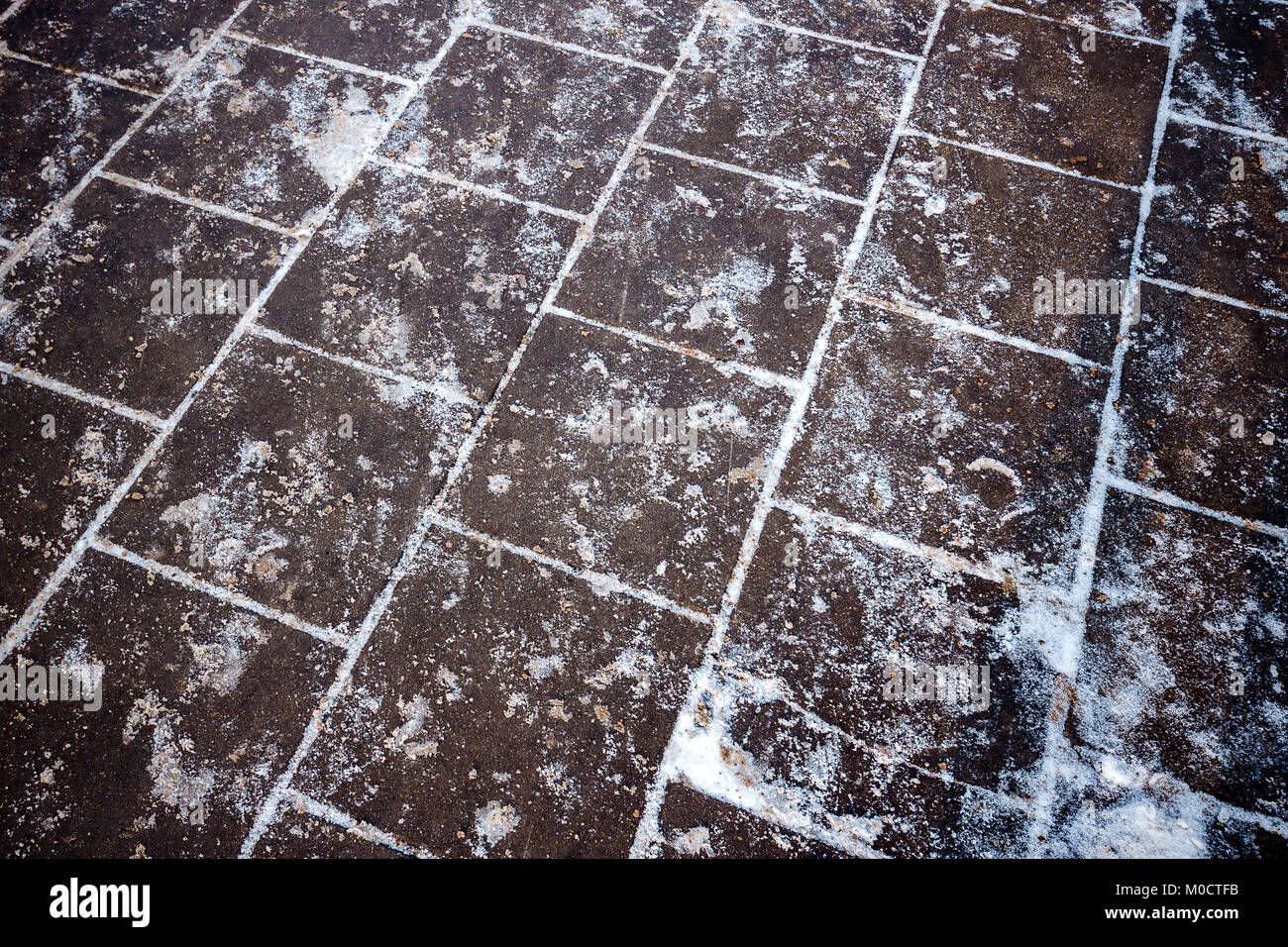 Concrete tiles paving texture with a little bit of snow Stock Photo - Alamy