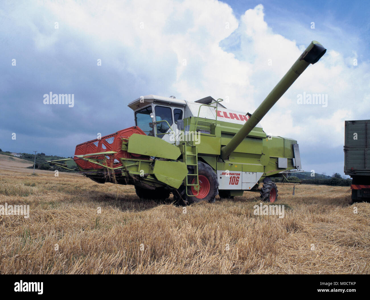 ireland, large farm combined harvester harvesting grain cereal crop ...