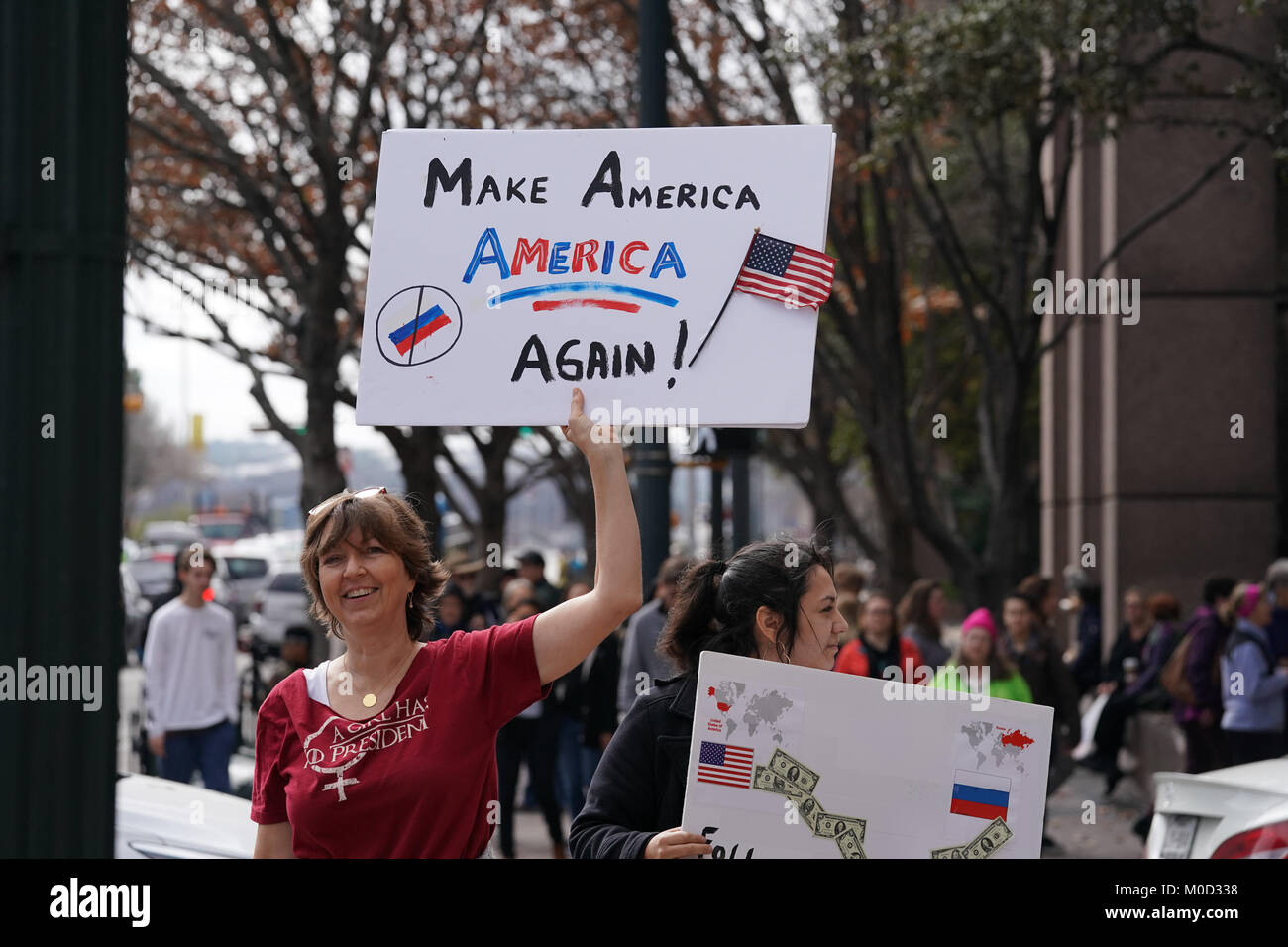 Protesters hold signs as Texas women and men march up Congress Avenue ...