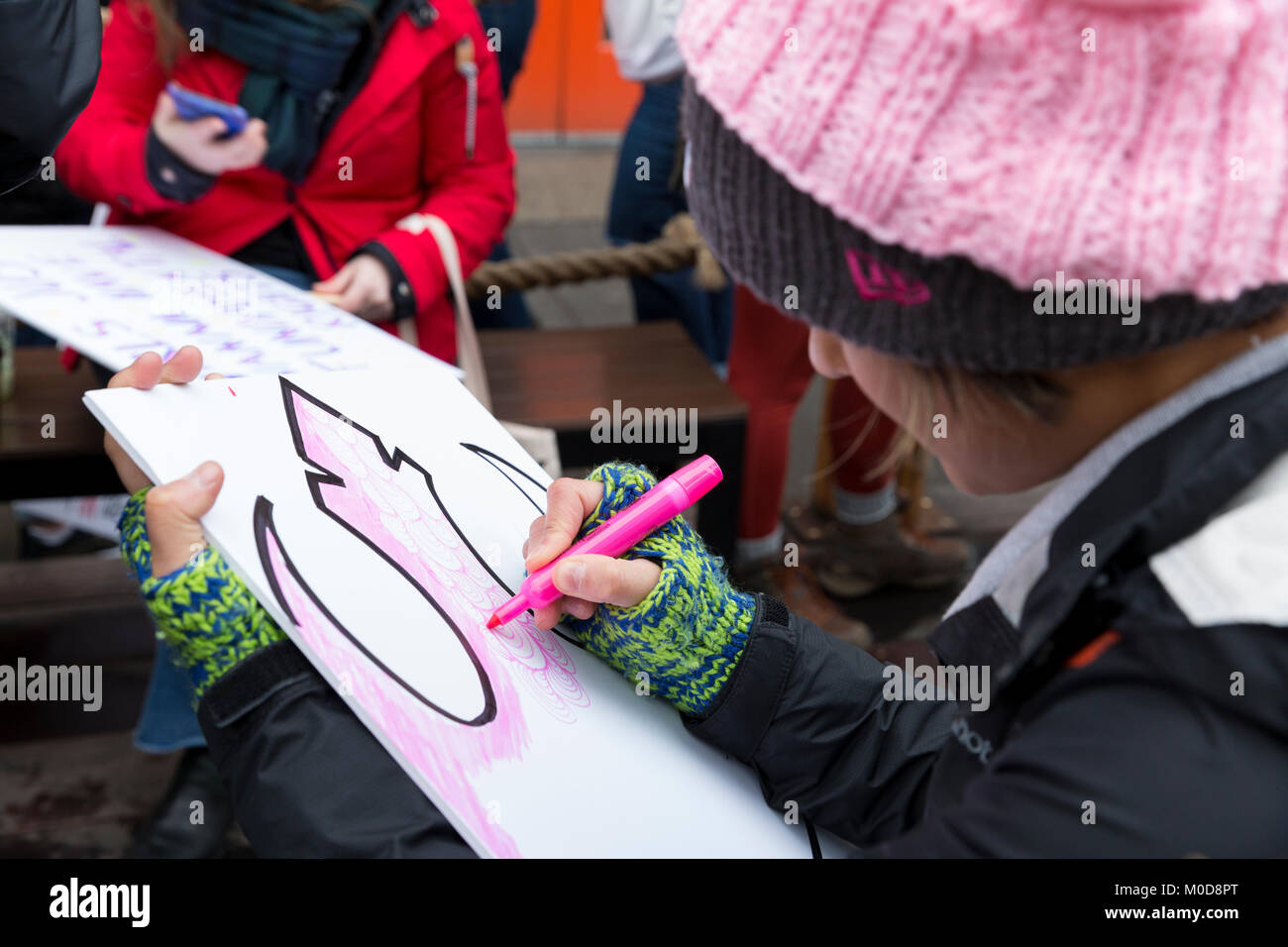 Seattle, Washington: Young woman drawing at the sign making prep rally ...