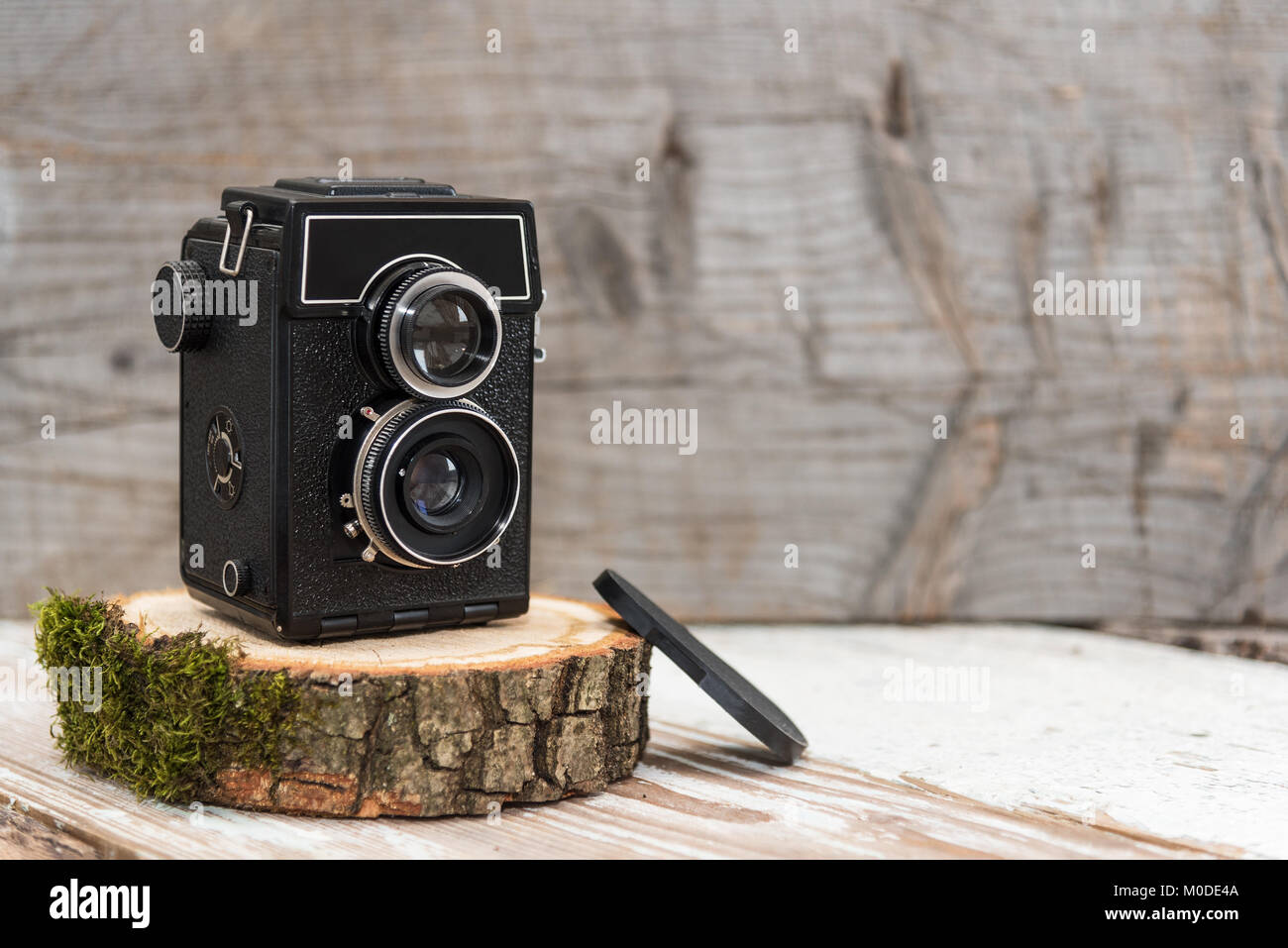 Old vintage camera on wooden stand, wooden background, retro theme ...