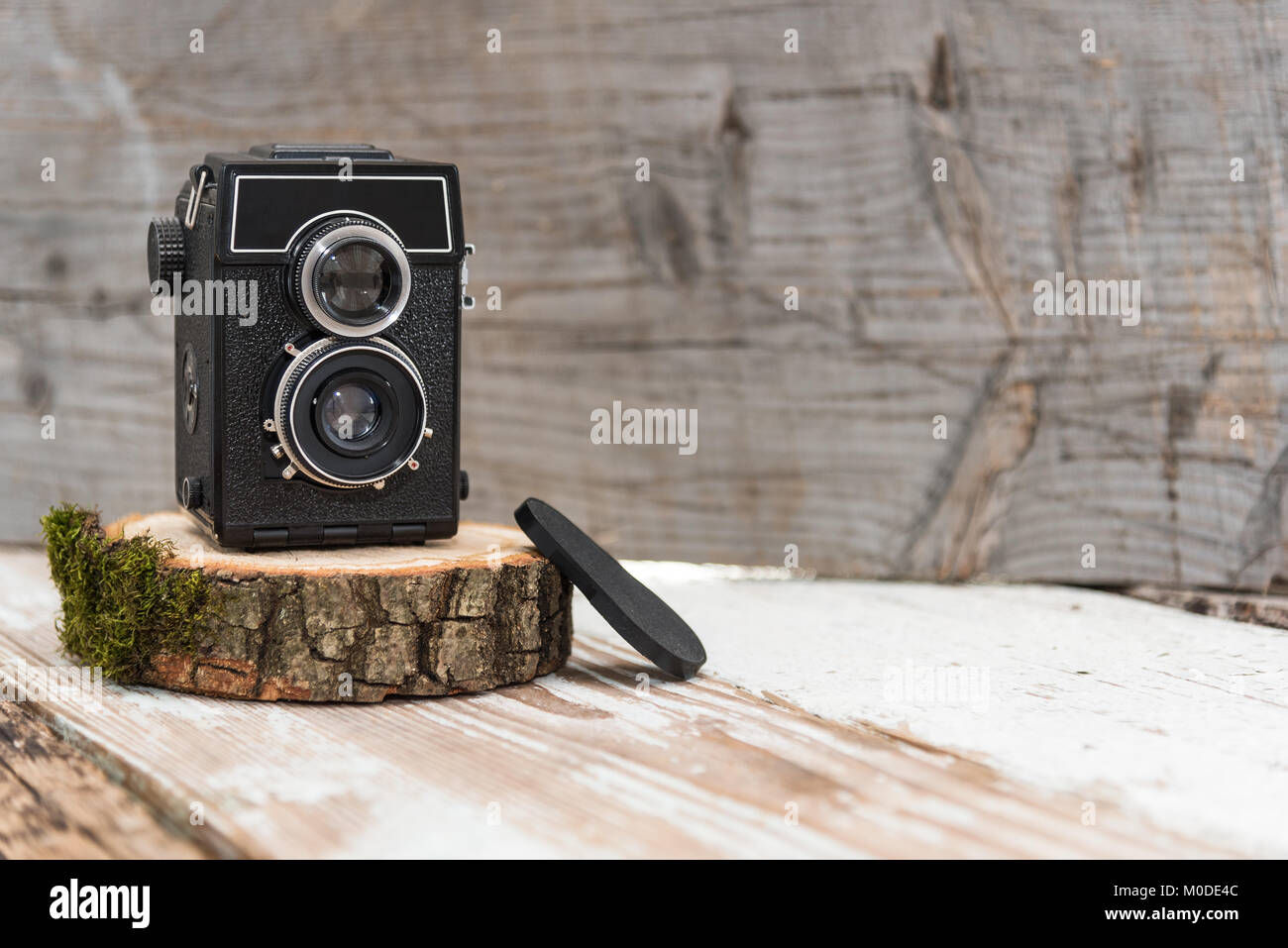 Old vintage camera on wooden stand, wooden background, retro theme ...